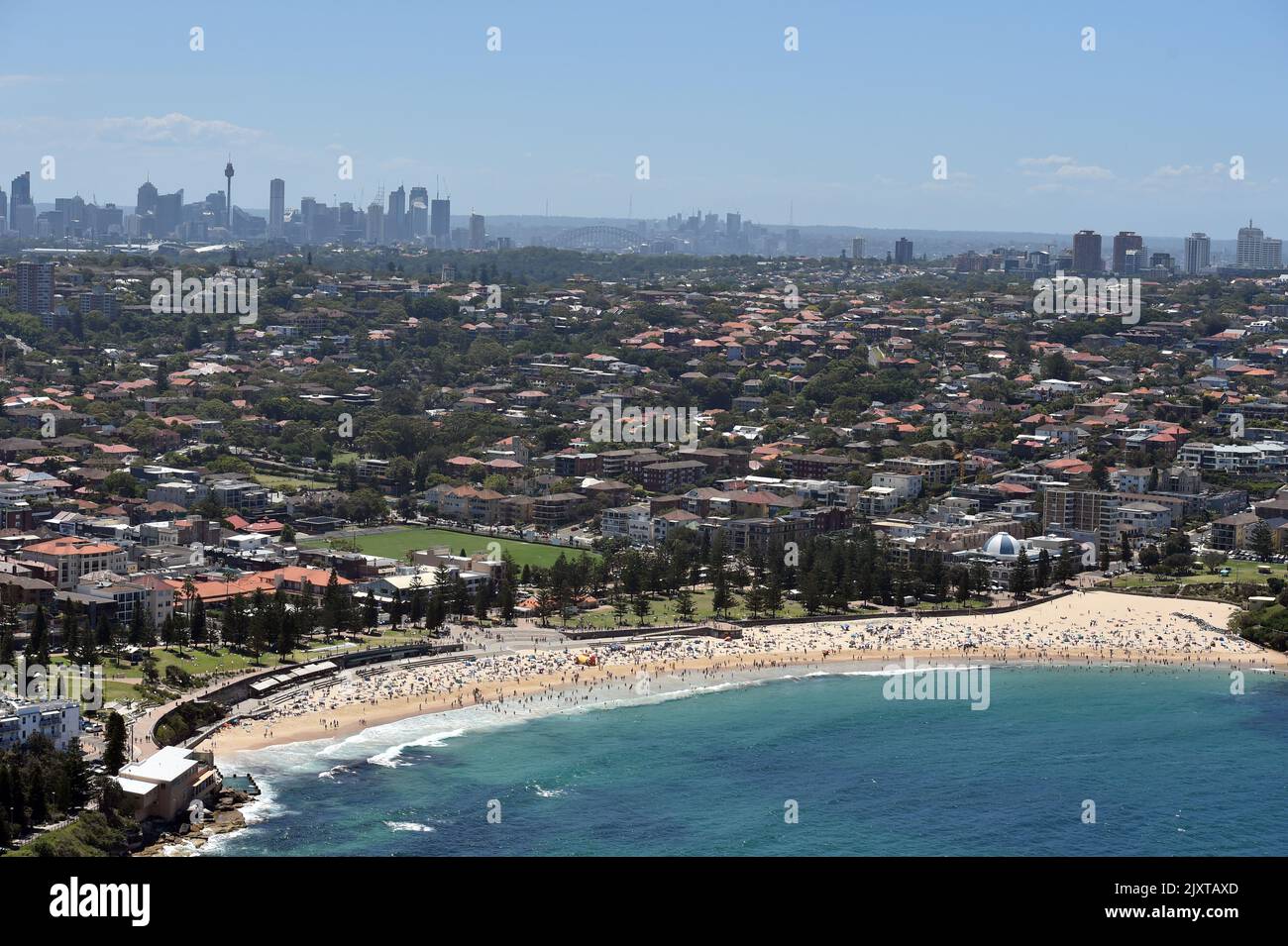 An aerial view of Coogee Beach and the city skyline in Sydney ...
