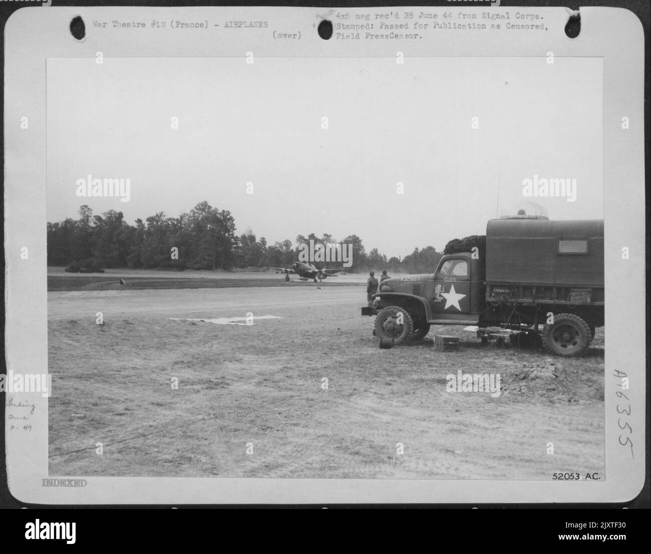 A P-47 fighter lands on the newly completed landing strip Stock Photo ...