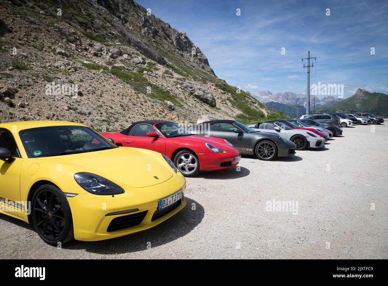 Row of Porsche sports cars in a mountain top car park, Dolomites, Italy ...