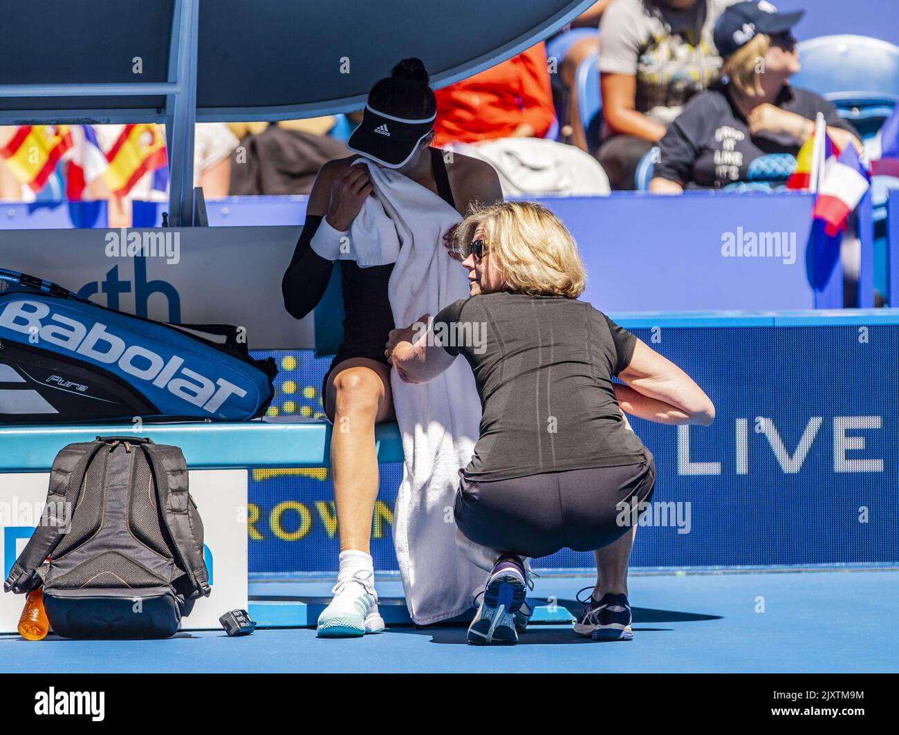 Garbine Muguruza of Spain receives medical attention during the women's ...