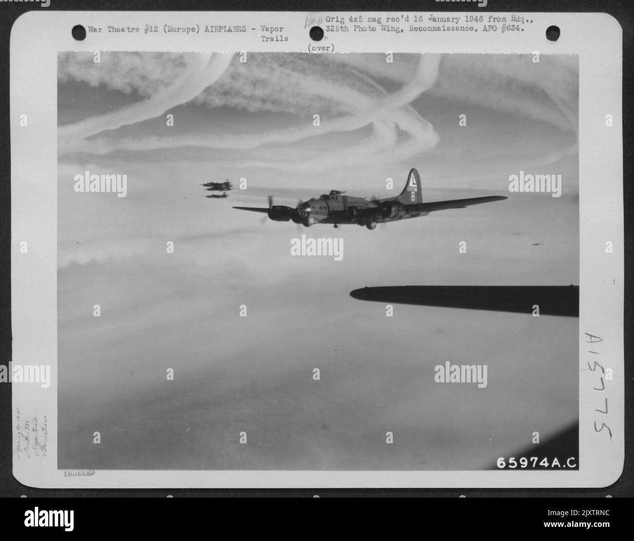 Against A Background Of Vapor Trails Left By Preceding Heavy Bombers, A ...