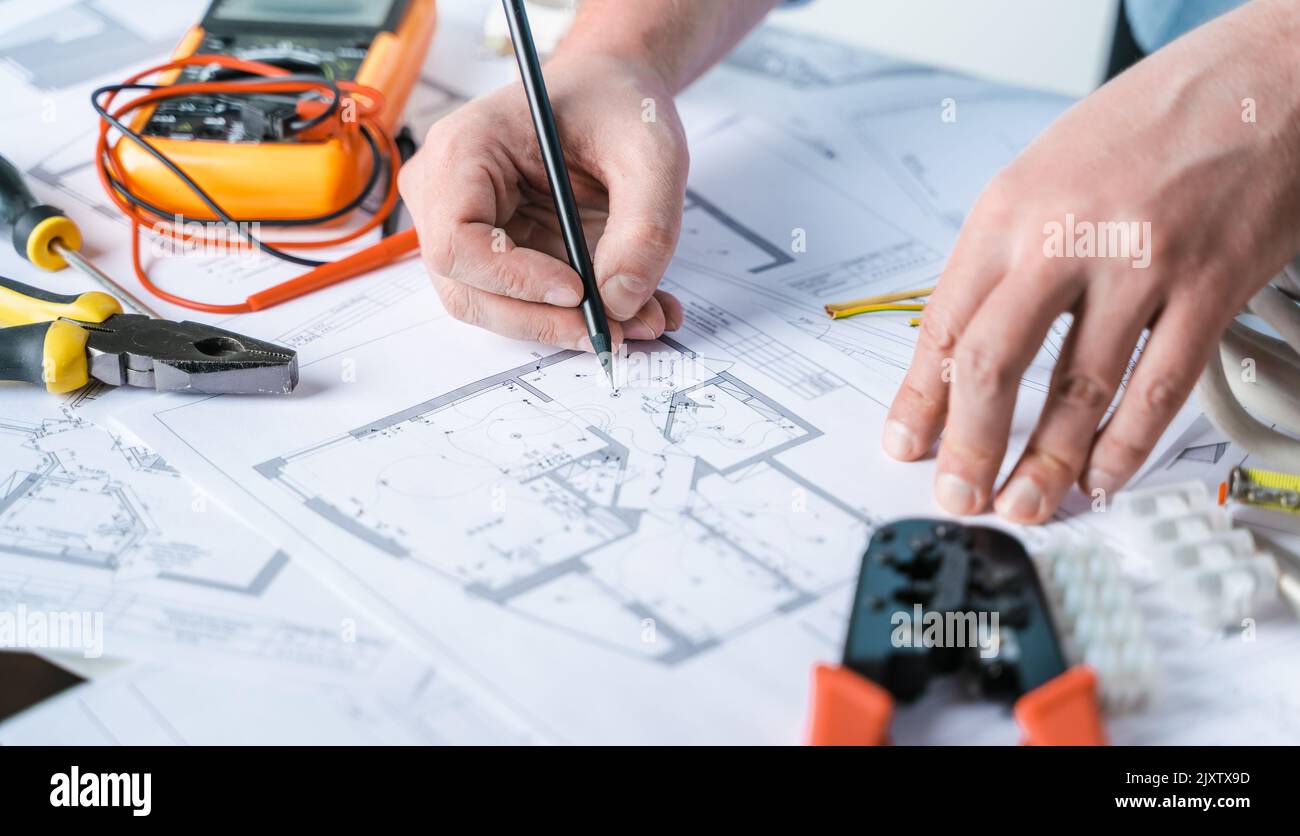 Man repairer making electricity project in house.Repairs planning ...