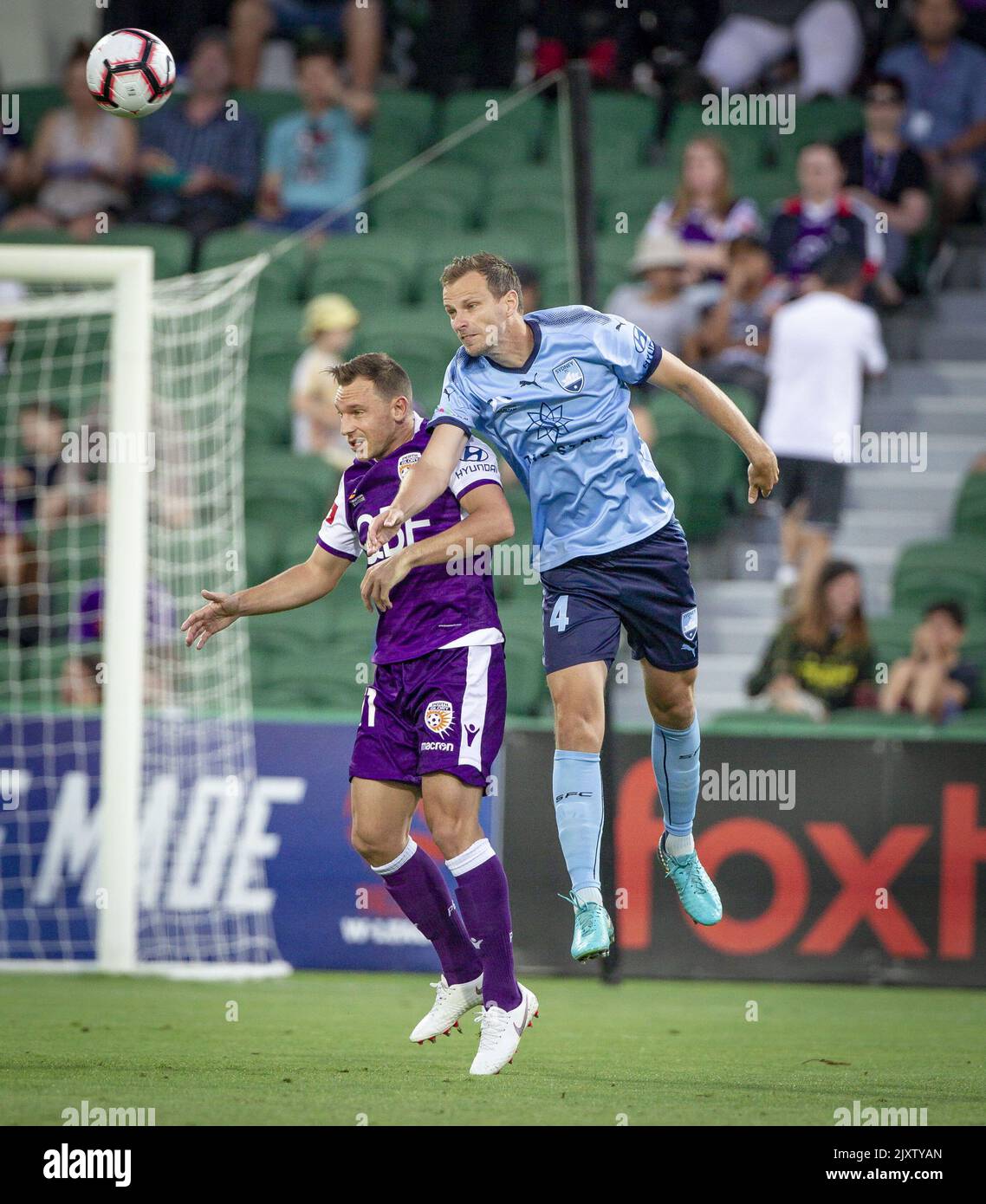 Brendon Santalab of the Glory and Alex Wilkinson for Sydney FC during ...