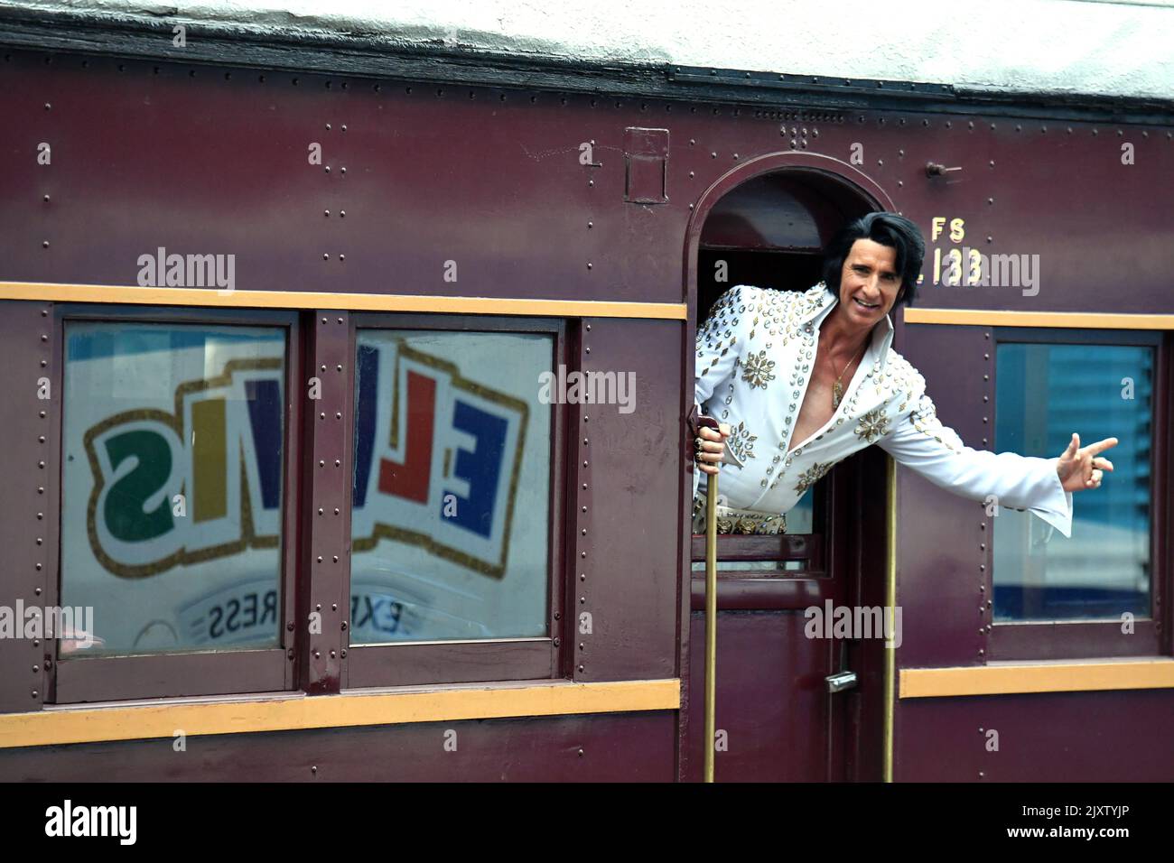 Elvis impersonator Kingsley Rock poses for a photograph before boarding ...