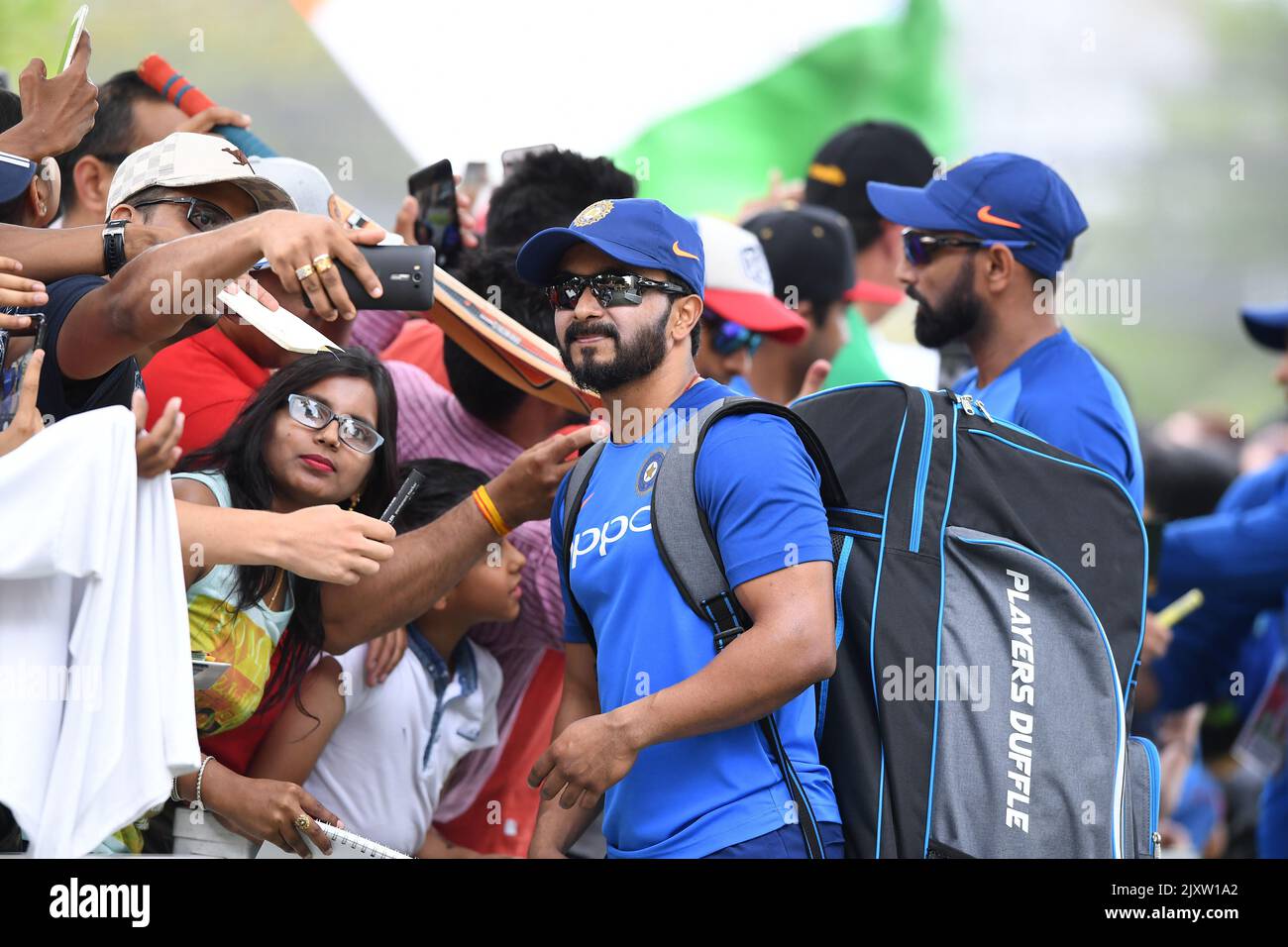 Kedar Jadhav of the Indian cricket team signs autographs following a ...
