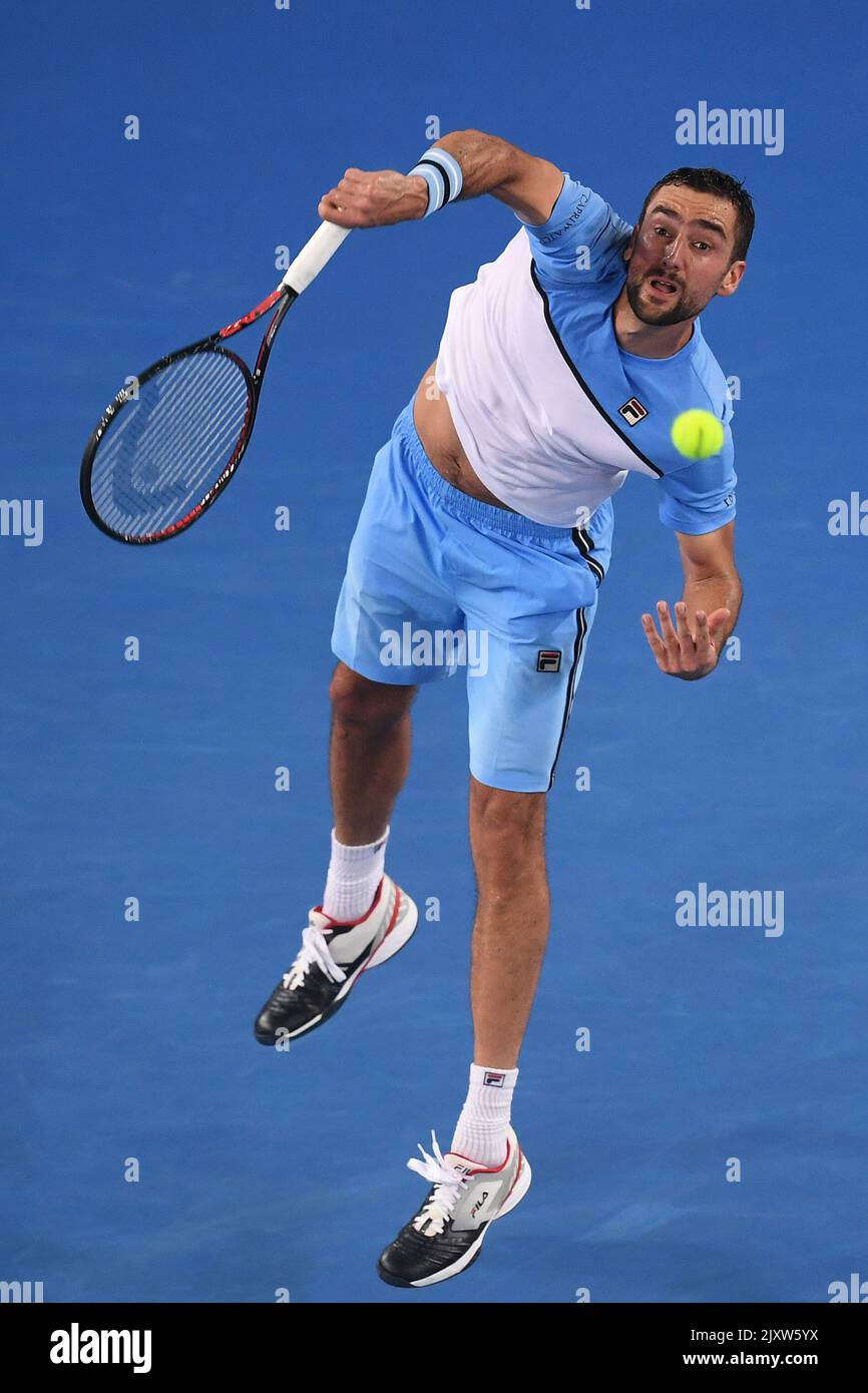 Marin Cilic of Croatia in action against Bernard Tomic of Australia ...