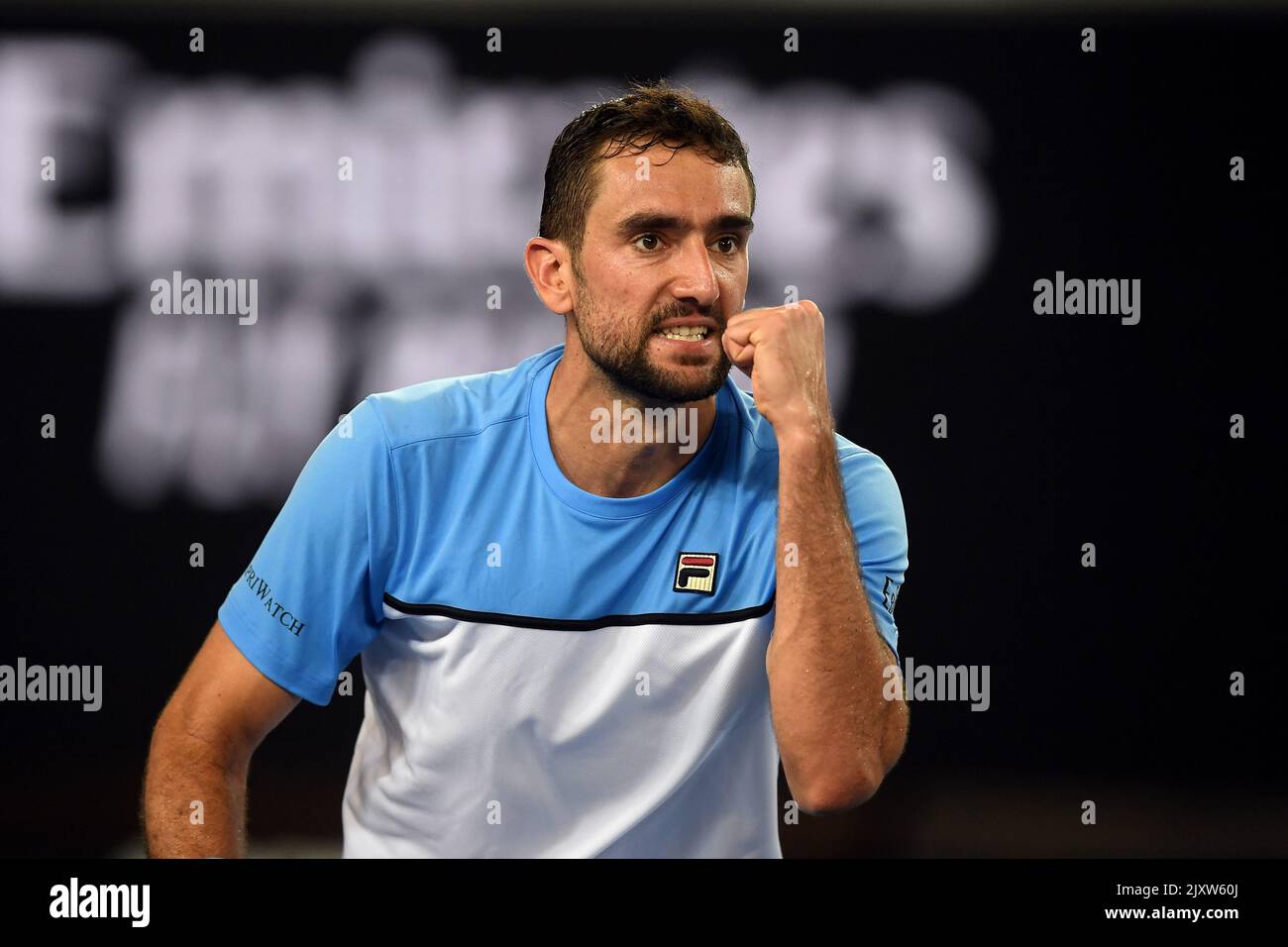 Marin Cilic of Croatia in action against Bernard Tomic of Australia ...