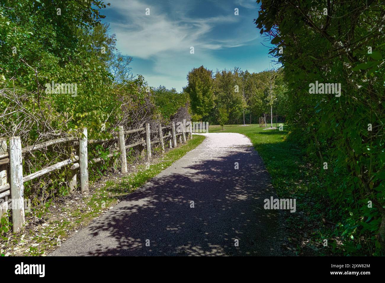 Wooden fence made of round wooden poles along the turn of the road in ...