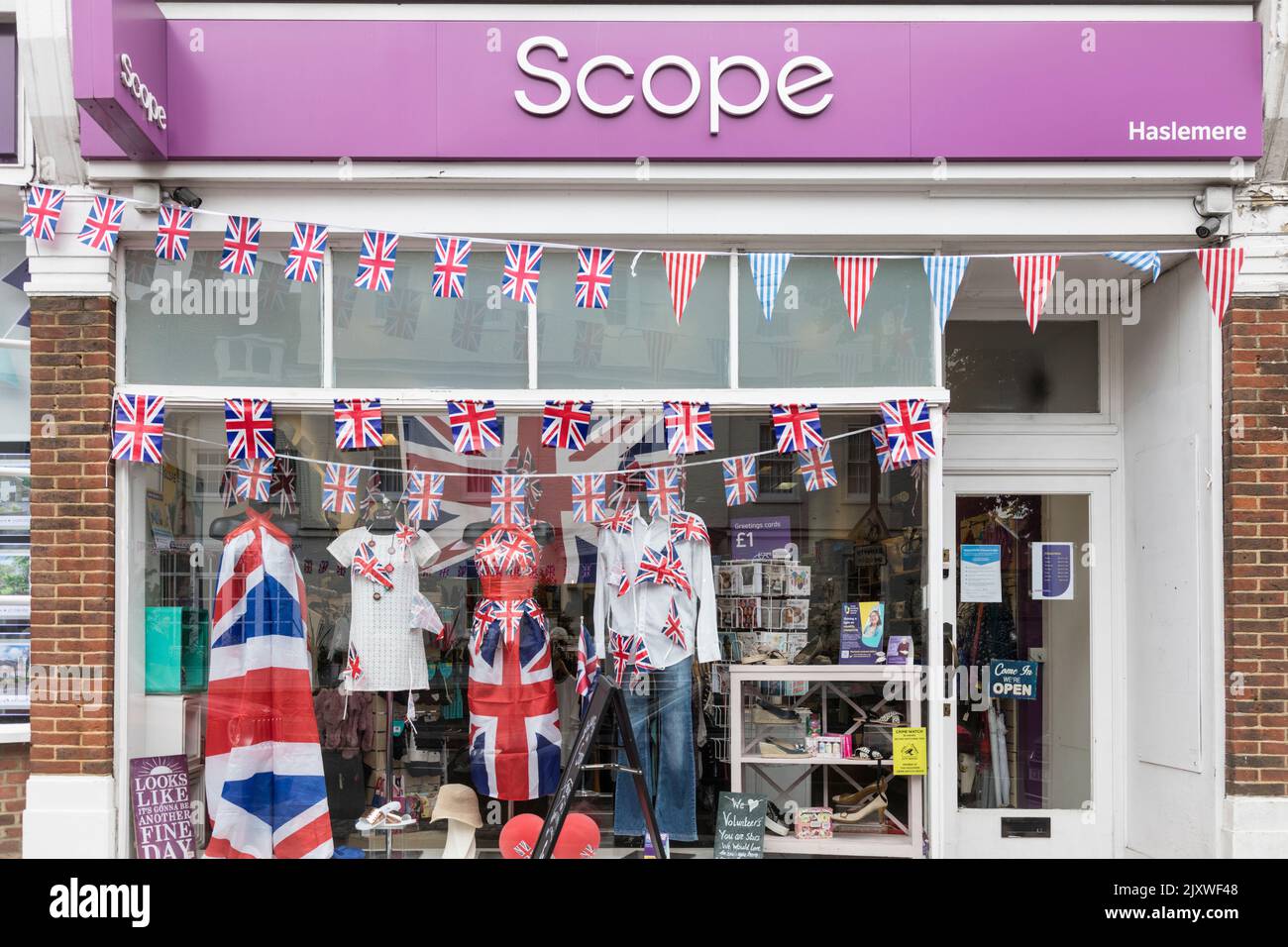 Bunting and Union flags fill the window of a shop in Haslemere to ...