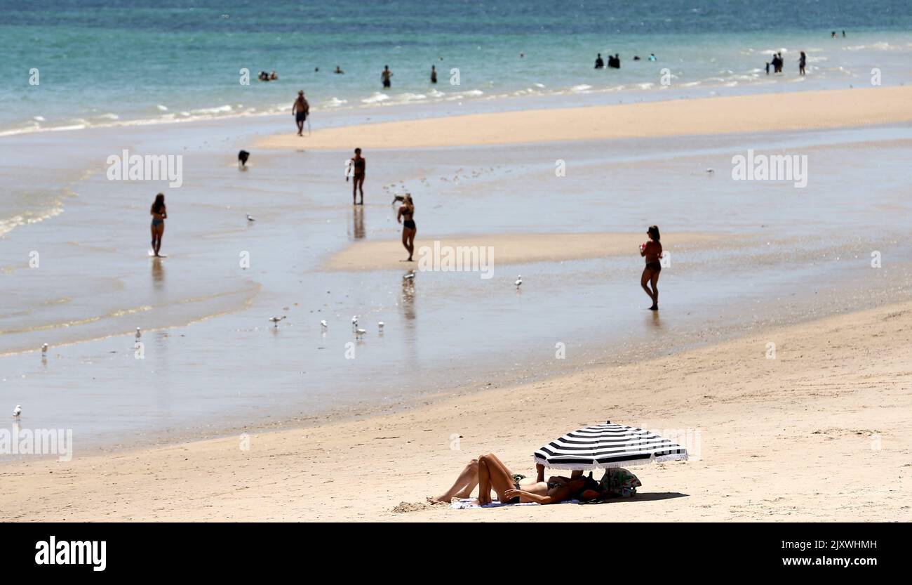 Beachgoers cool off at Brighton beach during a hot day in Adelaide ...