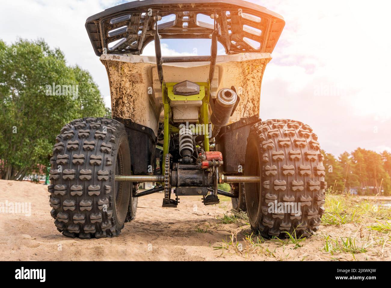 Rear view of the ATV standing on sandy ground Stock Photo - Alamy
