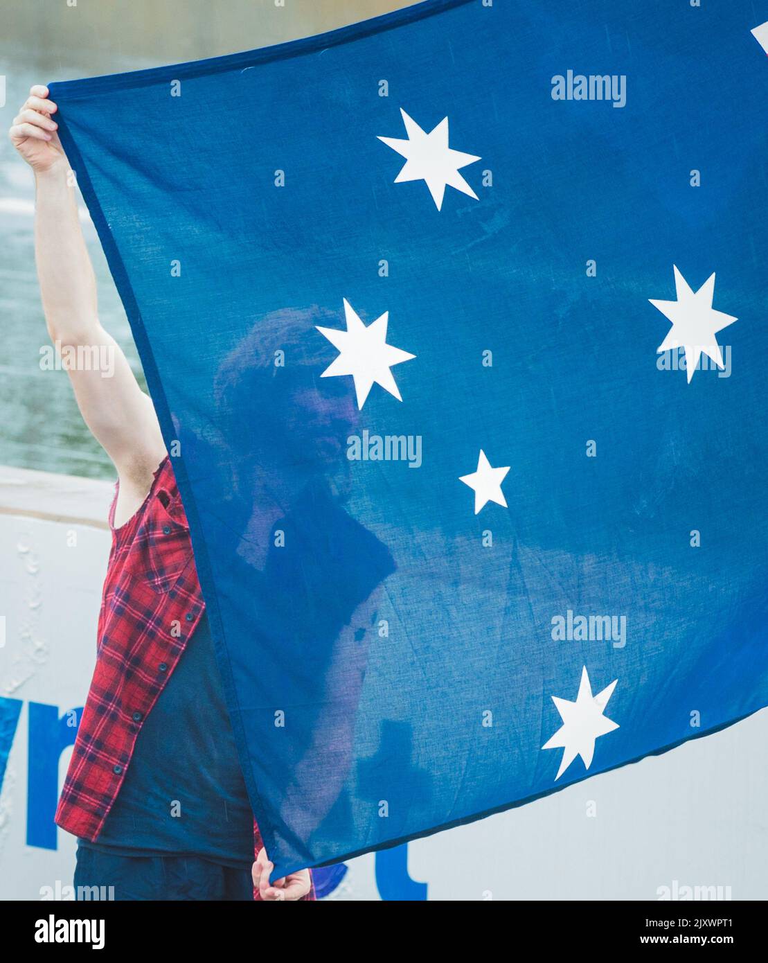 A participant holds an Australian flag during Australia Day Ute Run in ...