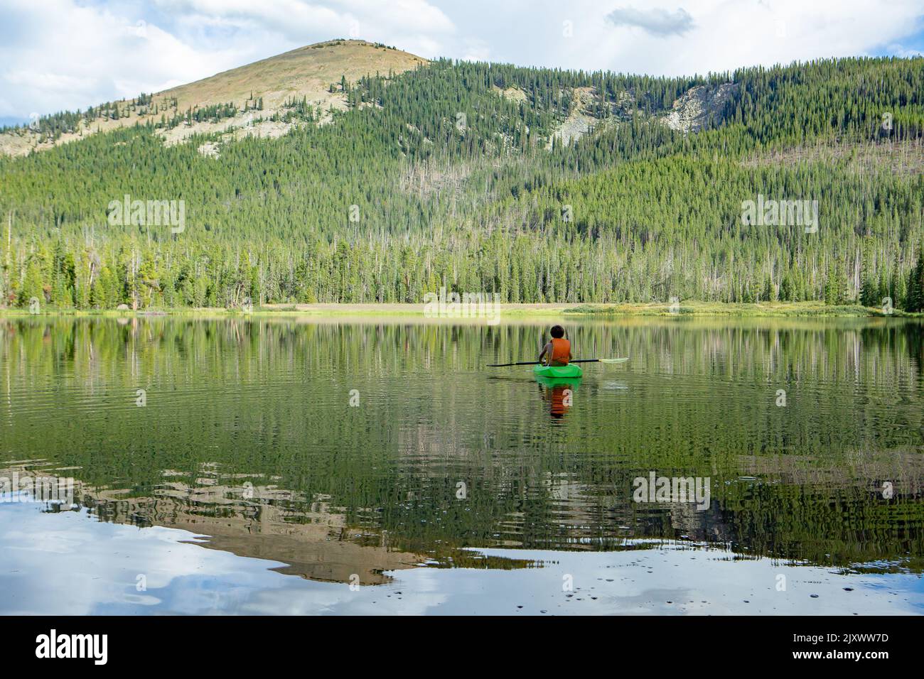 Boy kayaking on mountain lake hi-res stock photography and images - Alamy