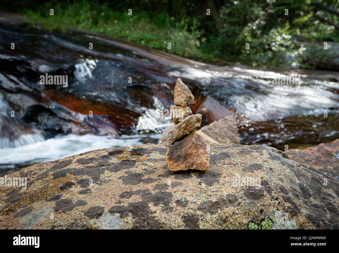 Rock cairn by a river Stock Photo - Alamy