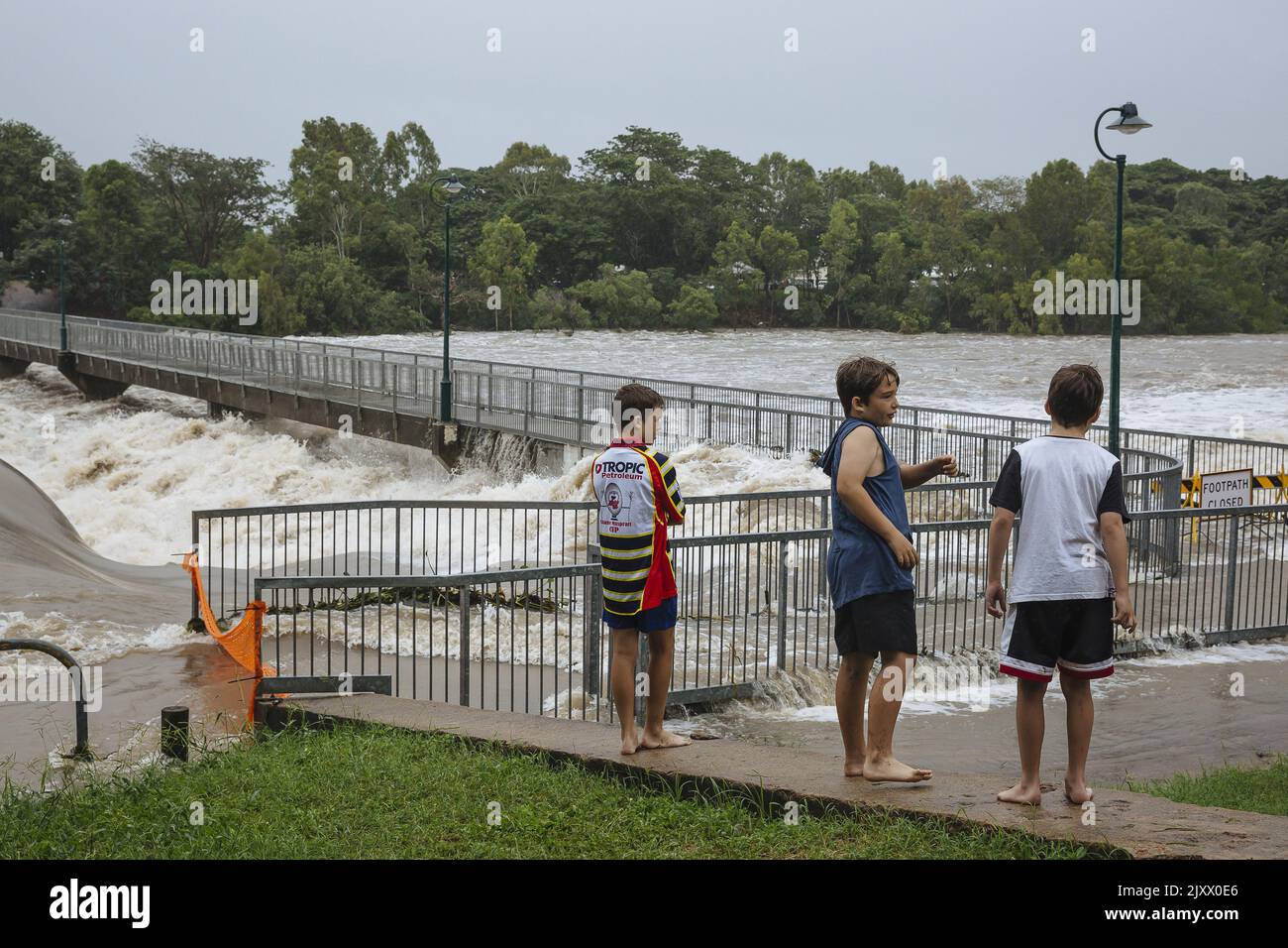 Locals observe floodwaters at Black Weir in Townsville, Friday ...