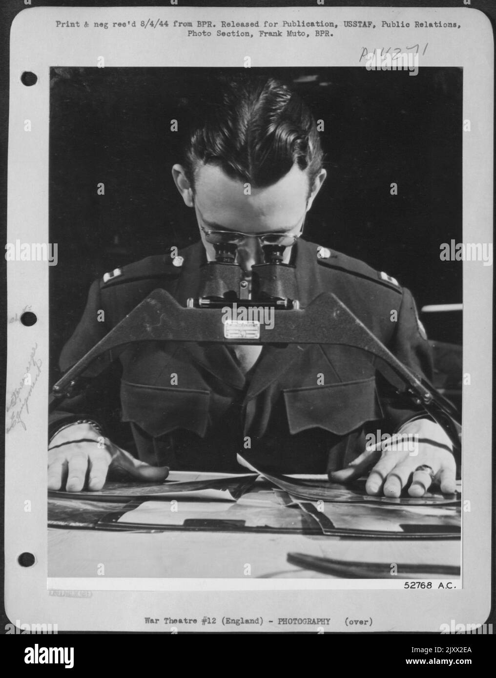 The photo intelligence officer studies photograph made from the film ...