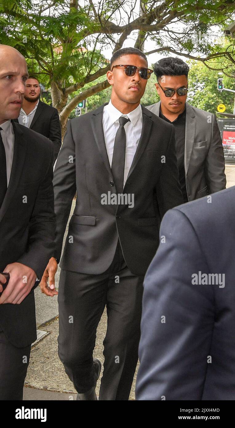NRL player Michael Kam (centre) and his younger brother Livingston Kam ...