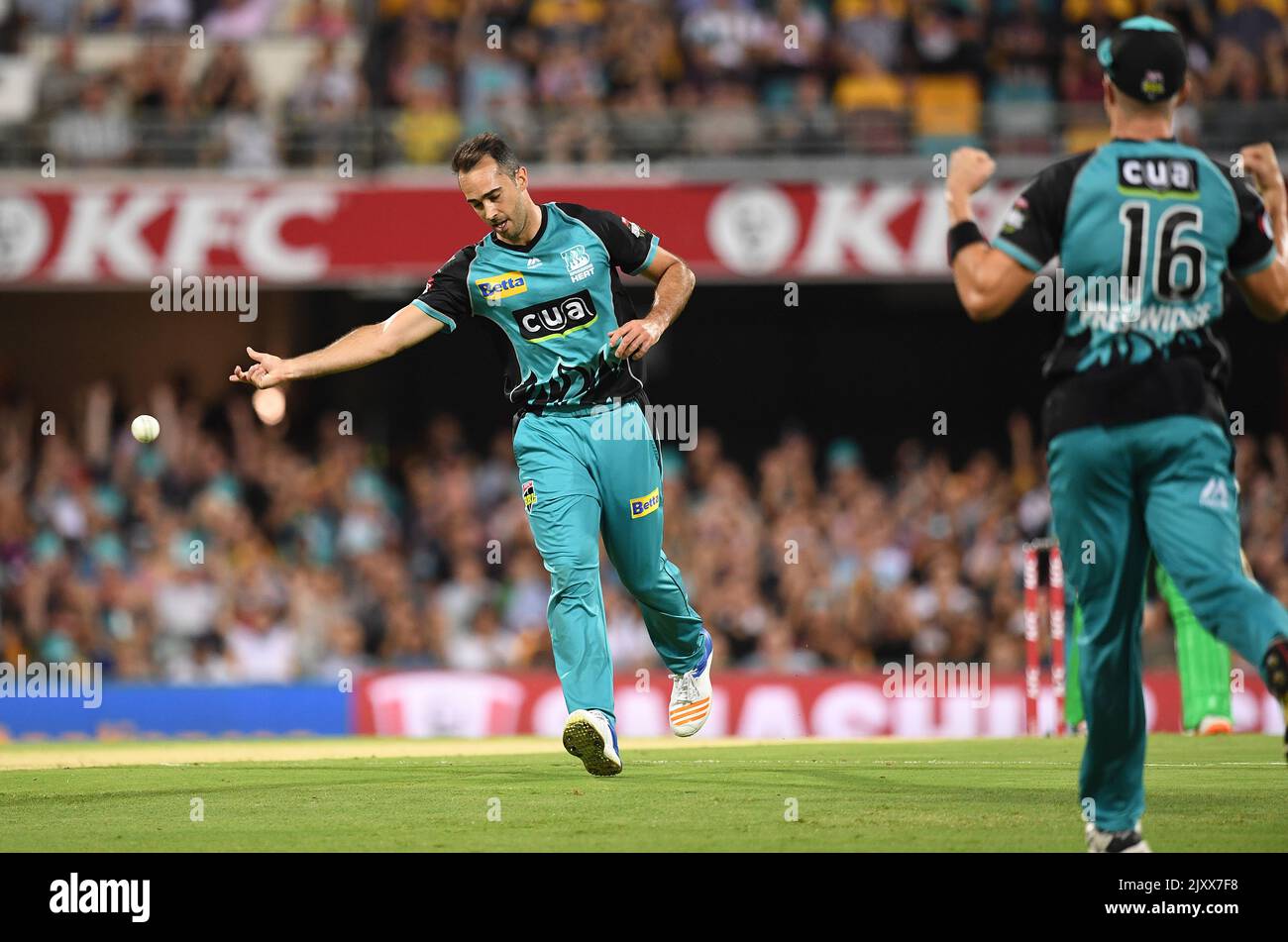 Josh Lalor of the Heat (left) reacts after dismissing Glenn Maxwell of ...