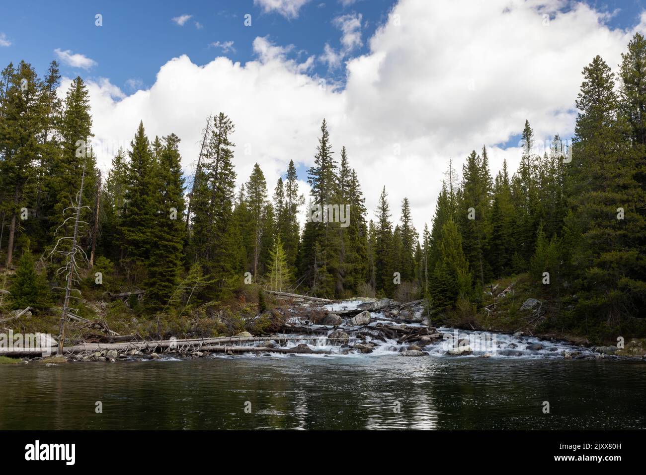 String Lake pouring over a small waterfall as it nears Jenny Lake ...