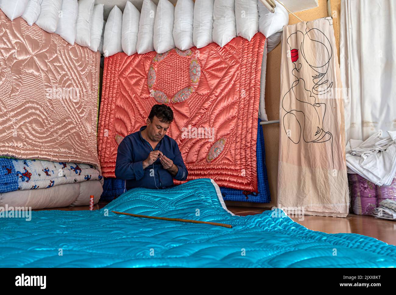 quilt maker makes quilts using wool and linen by hand Stock Photo - Alamy