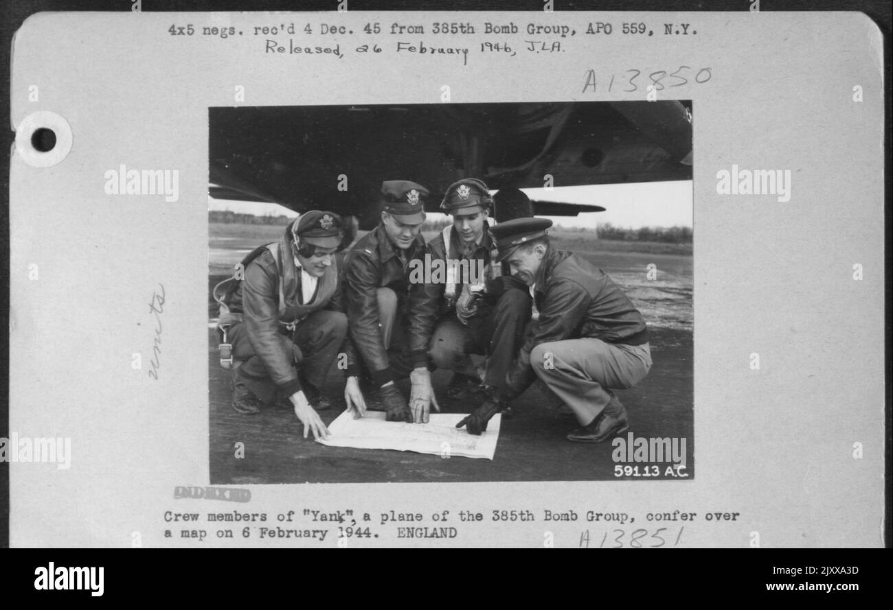 Crew Members Of "Yank" A Plane Of The 385Th Bomb Group, Confer Over A ...