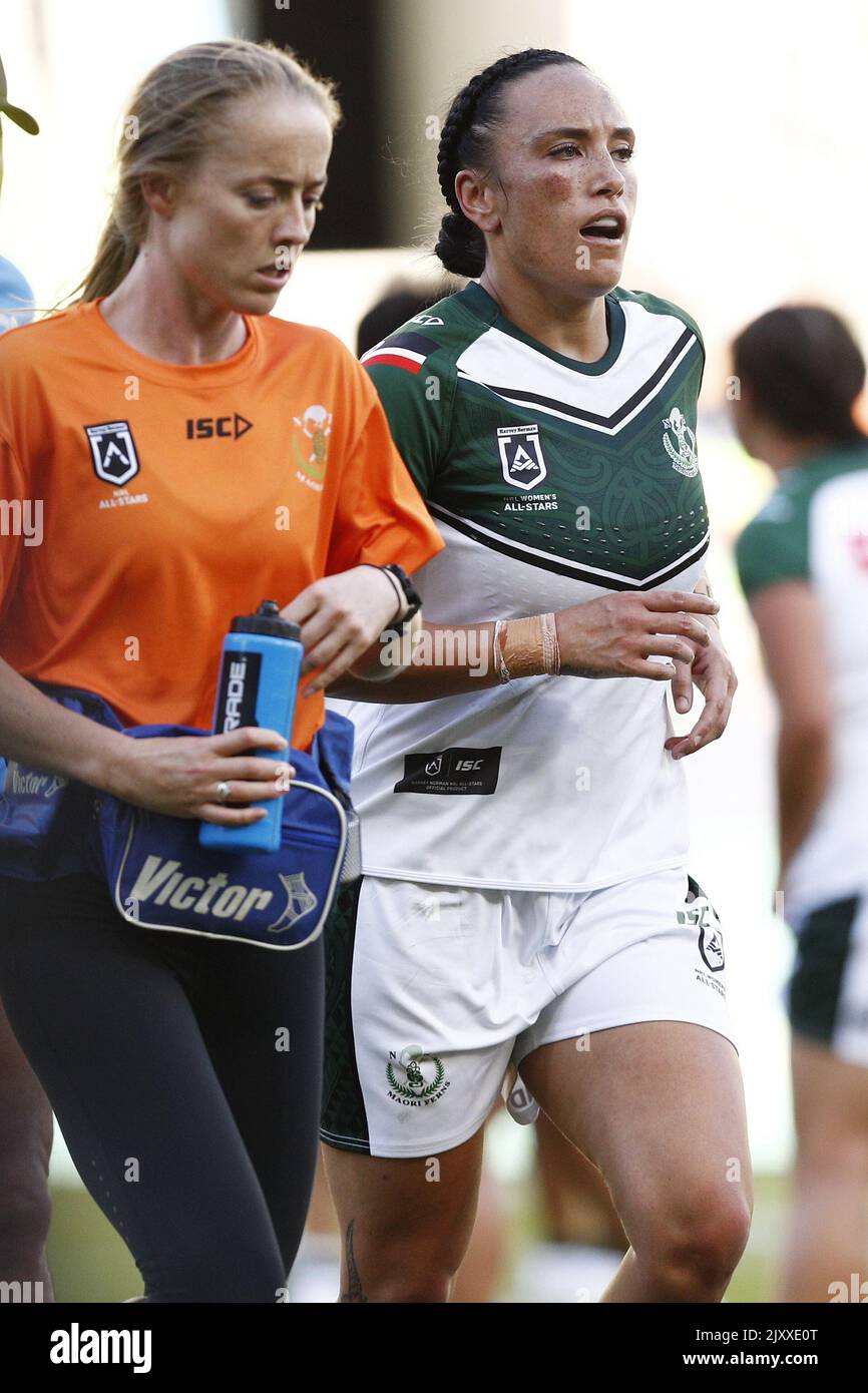 Krystal Rota of the New Zealand Maori Ferns runs with a trainer during ...