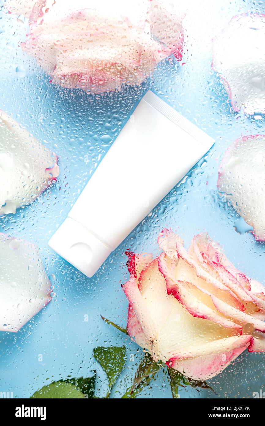 cosmetic tube for face cream, cleanser or body lotion on a blue ...