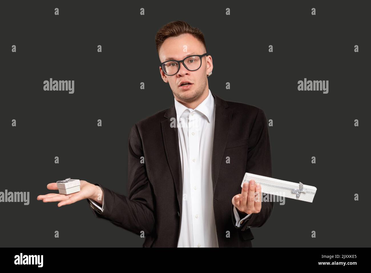 special gift confused business man jewelry boxes Stock Photo - Alamy