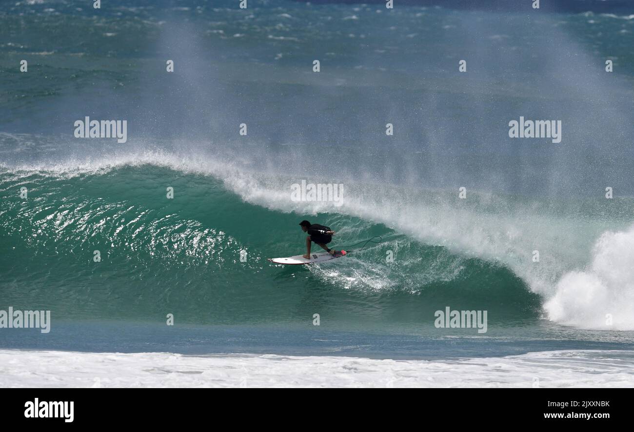 A surfer is seen riding a wave at Kirra on the Gold Coast, Saturday ...