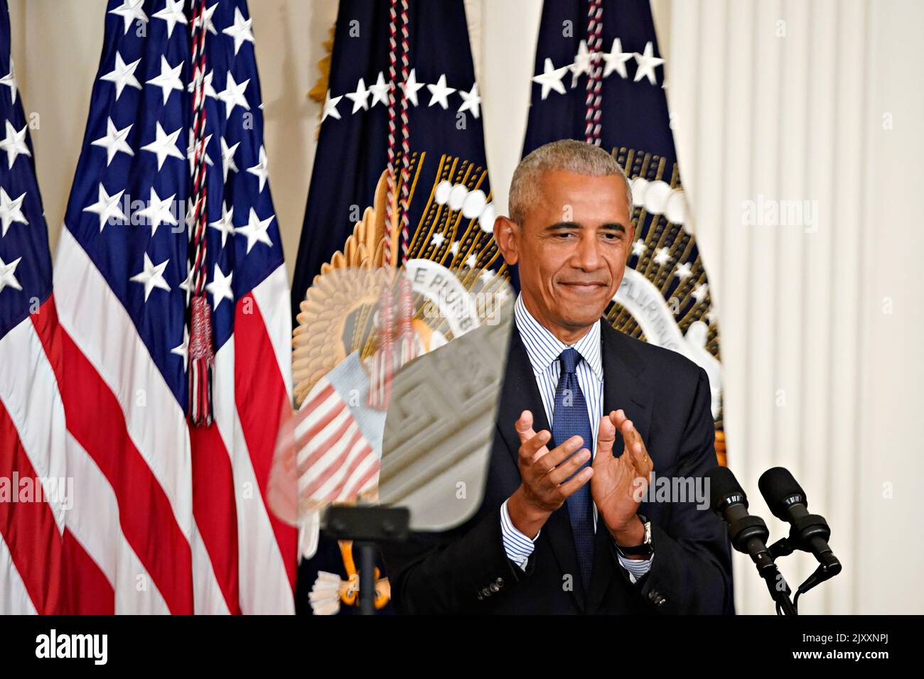 Former United States President Barack Obama claps while speaking during ...
