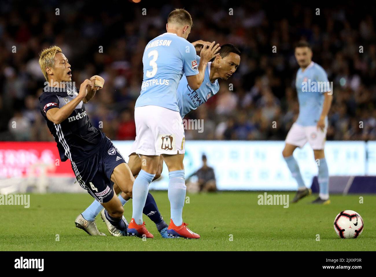 Keisuke Honda of the Victory is tackled by Scott Jamieson and Kearyn ...