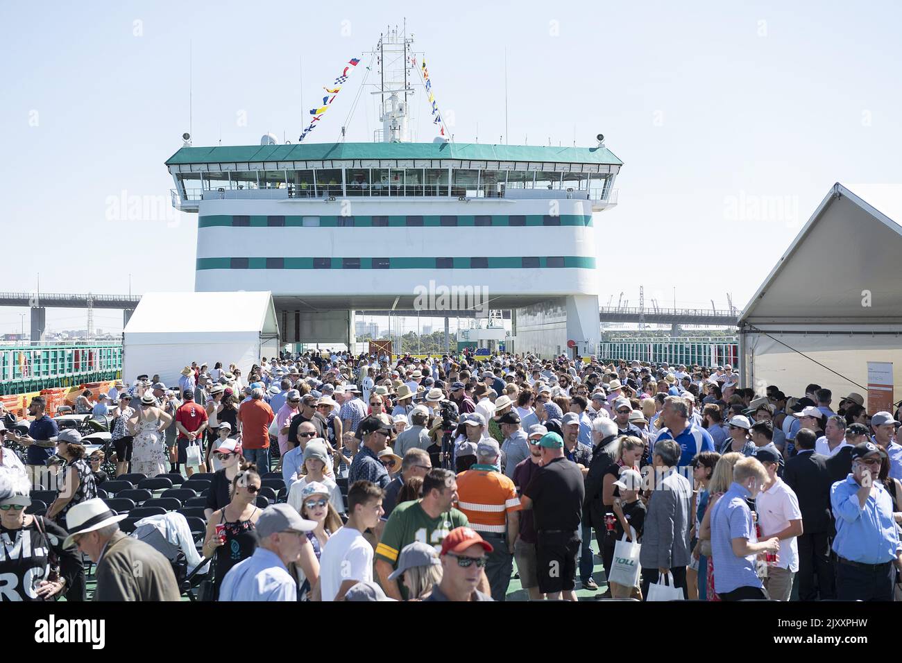 A large crowd of Toll workers and their families are seen on the deck ...