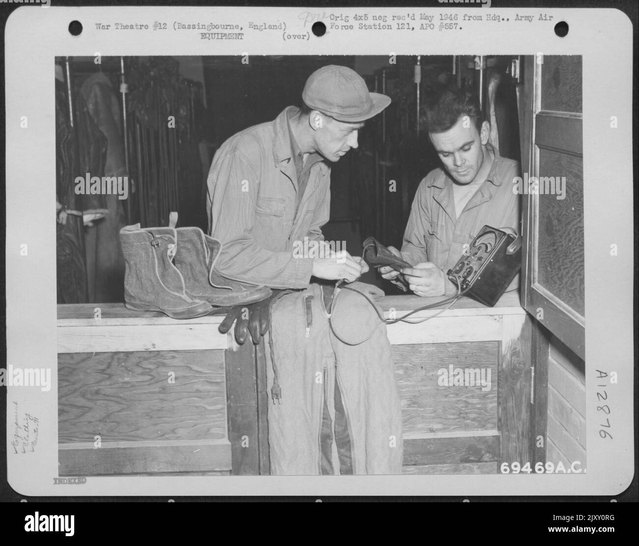 Men Check The Wiring In An Electronically-Heated Flying Suit And Gloves ...