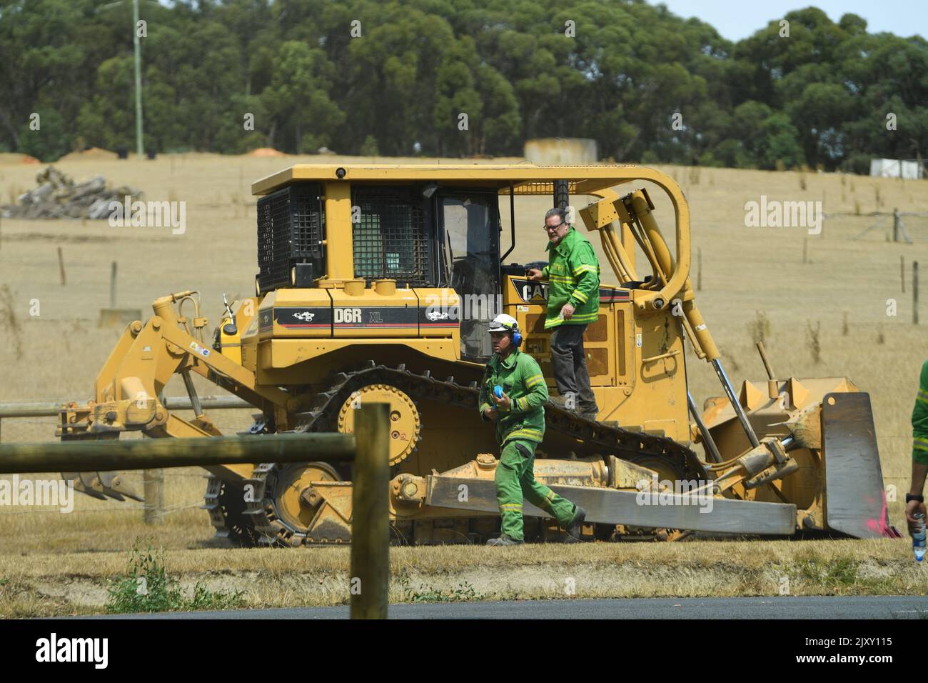 Victoria Parks forest fire management workers are seen with a bulldozer ...