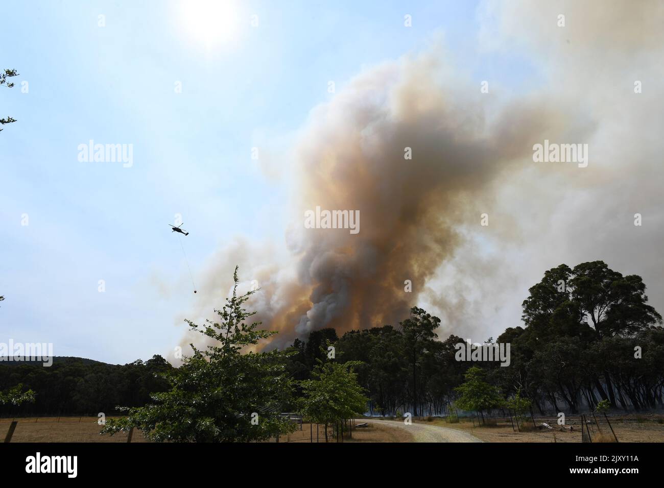 A water bombing helicopter is seen at near a fire in the Bunyip State ...
