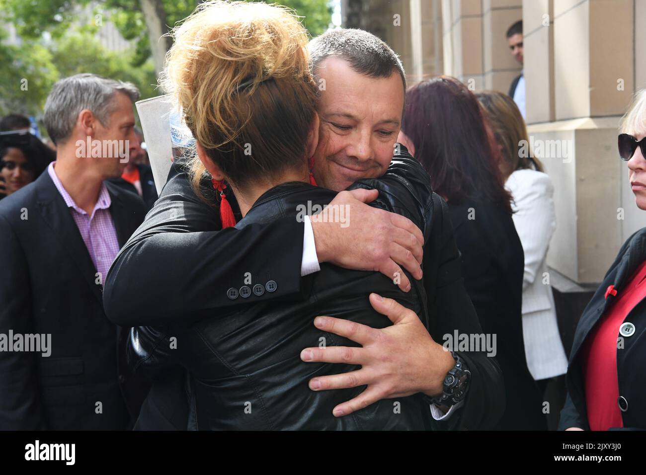 Boyd Unwin (centre right), the father of victim Katie Haley, is seen ...