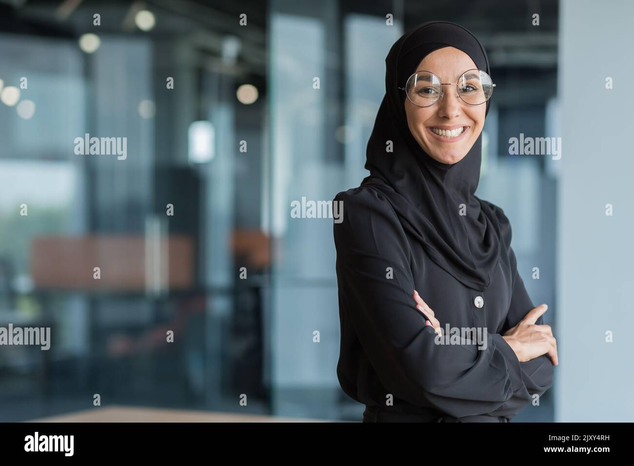 Portrait of muslim woman in hijab at work in office, business woman ...