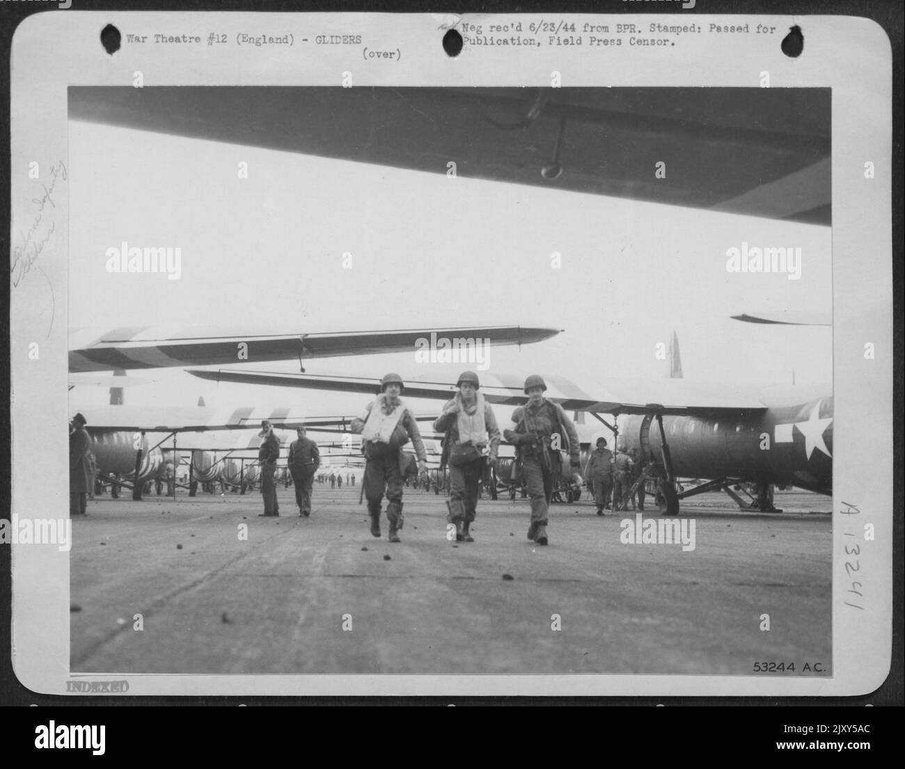 Three Americans airborne infantrymen walk beneath a canopy of waiting ...