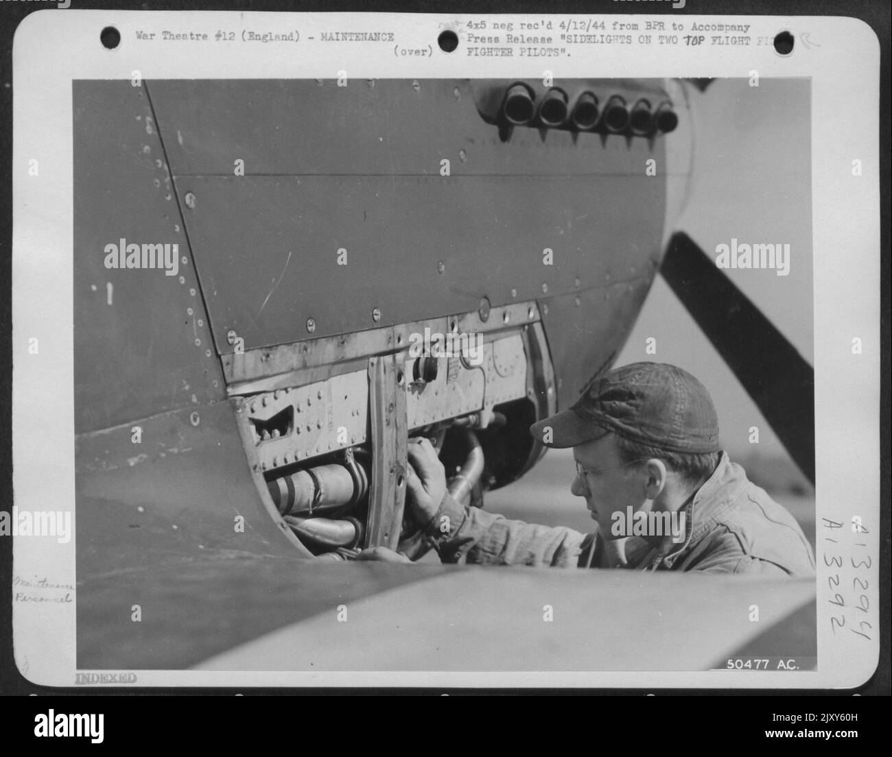 Sgt. Harry F. East, 27, Neb., works on the motor of a P-51. This is the ...