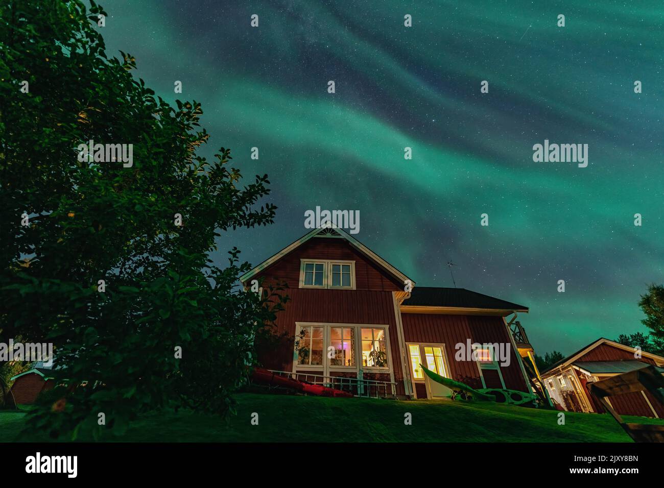 Dancing Northern lights Aurora borealis in autumn over wooden house in ...