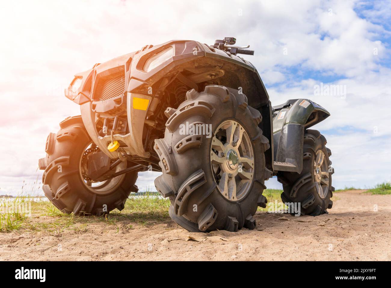 ATV on the sandy shore of the lake. front side view Stock Photo - Alamy