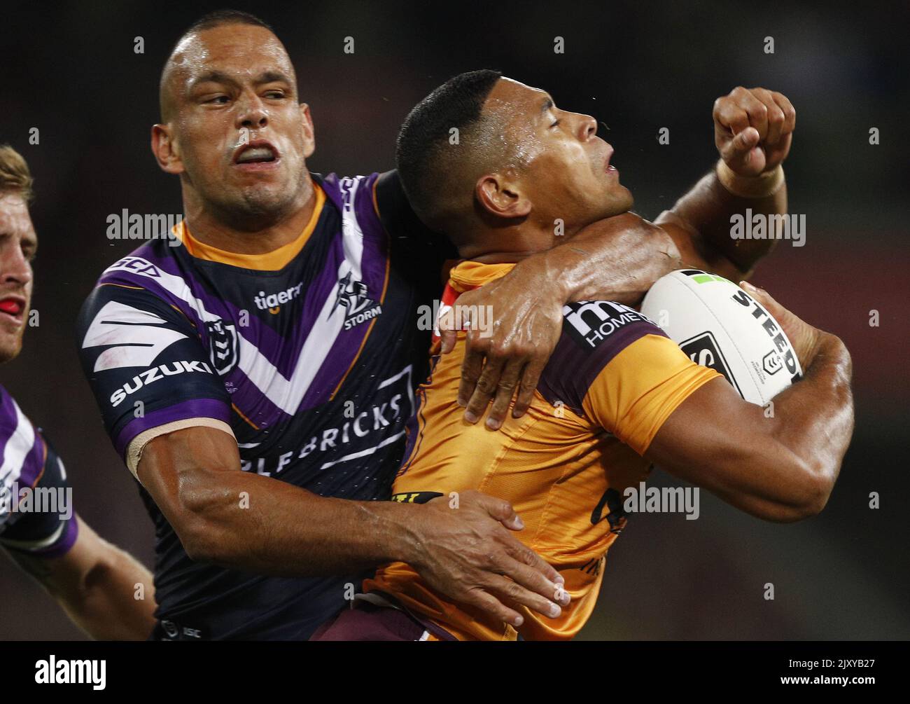 Jamayne Isaako of the Broncos is tackled by Will Chambers of the Storm ...