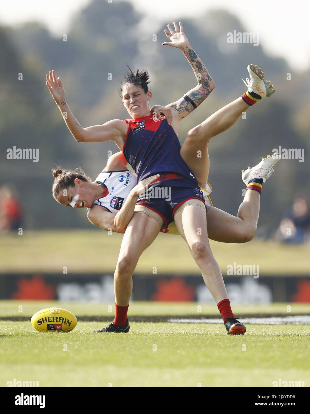Angela Foley of the Crows tackles Tegan Cunningham of the Demons during ...