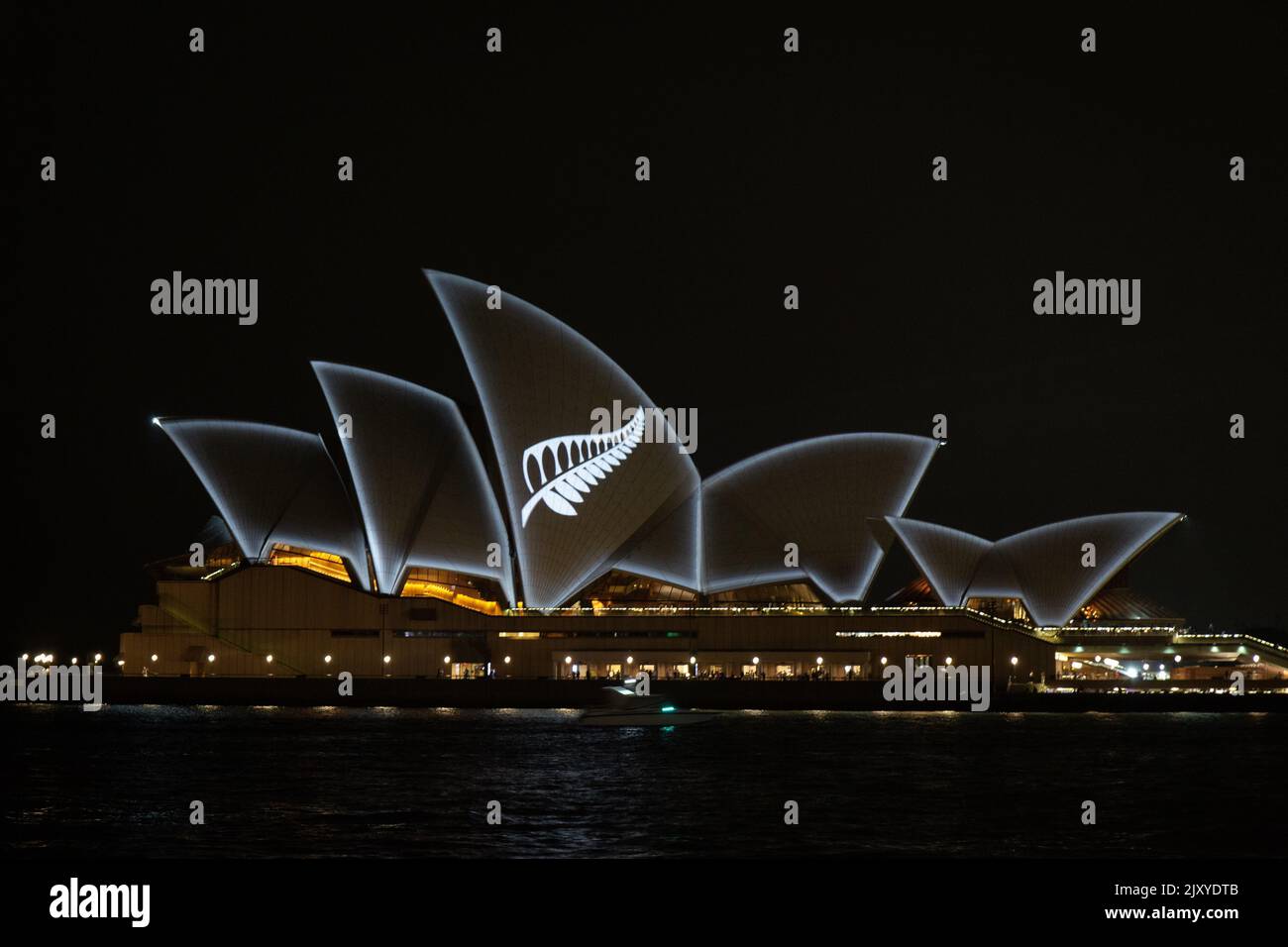 The Silver Fern of New Zealand is seen projected onto the sails of the ...