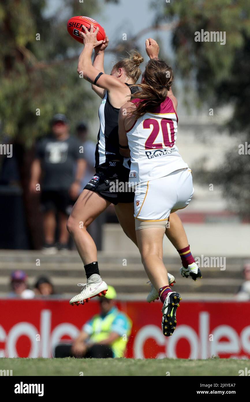 Jaimee Lambert of the Magpies marks in front of Shannon Campbell of the ...