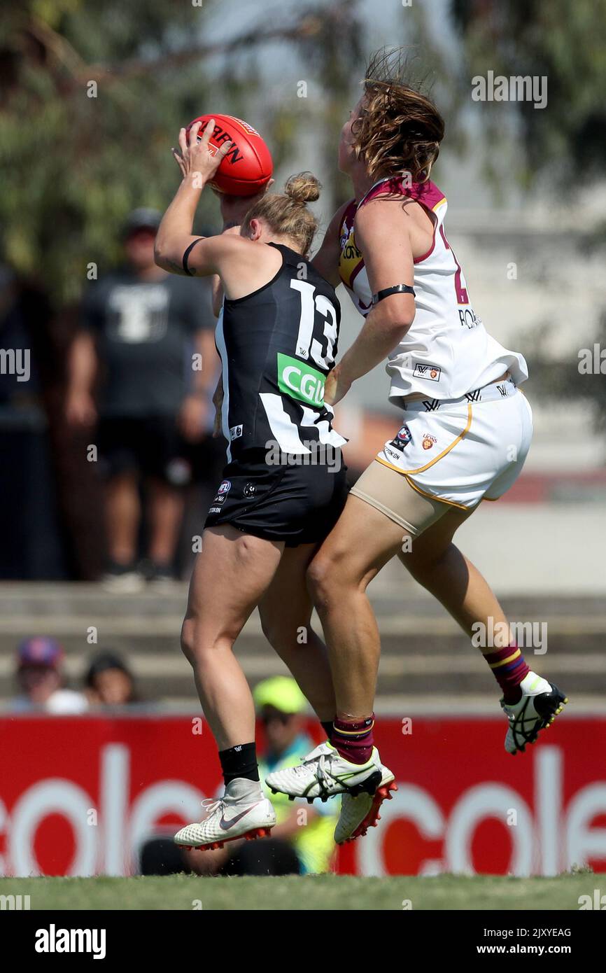Jaimee Lambert of the Magpies marks in front of Shannon Campbell of the ...