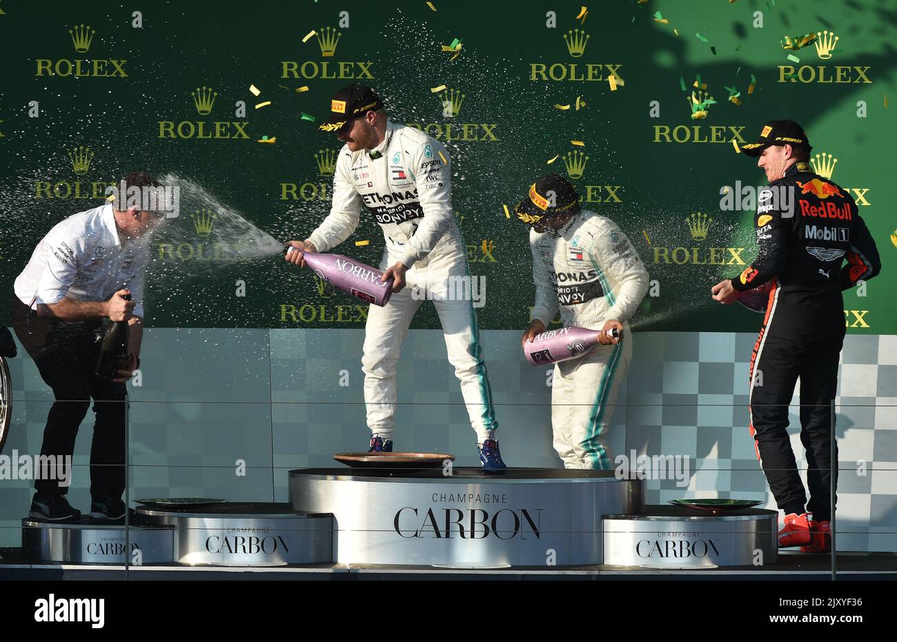 Valterri Bottas (2nd left) of Finland reacts after winning the Formula ...