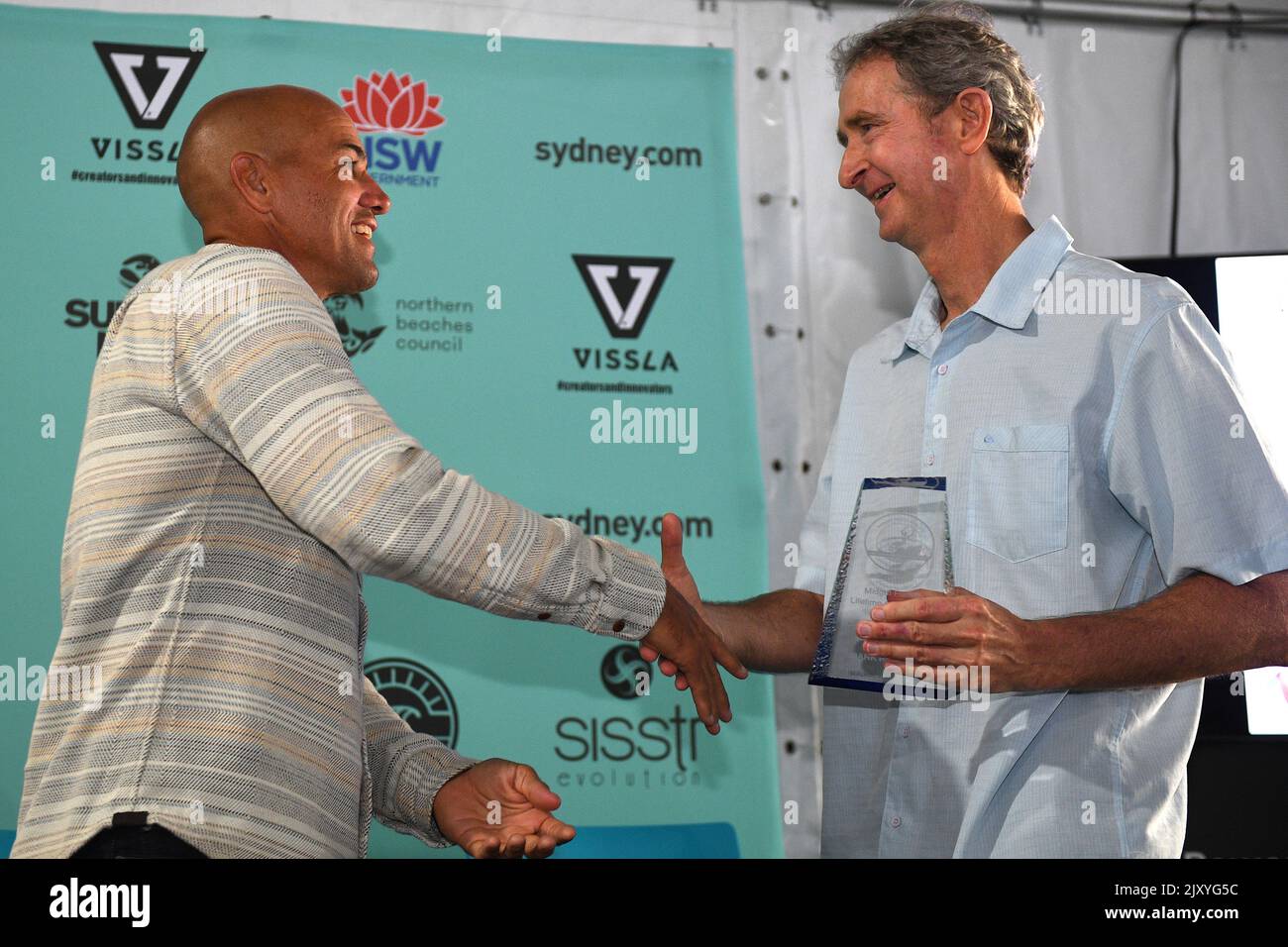 US surfer Kelly Slater (left) presents Australian surfer Mark Richards ...