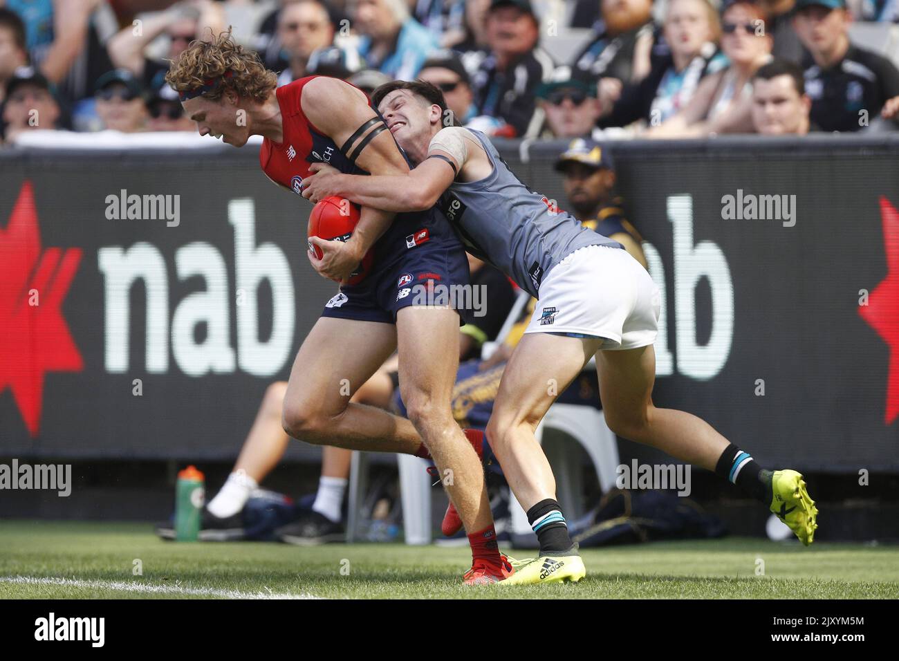 Jayden Hunt of the Demons is tackled by Zak Butters of the Power during ...