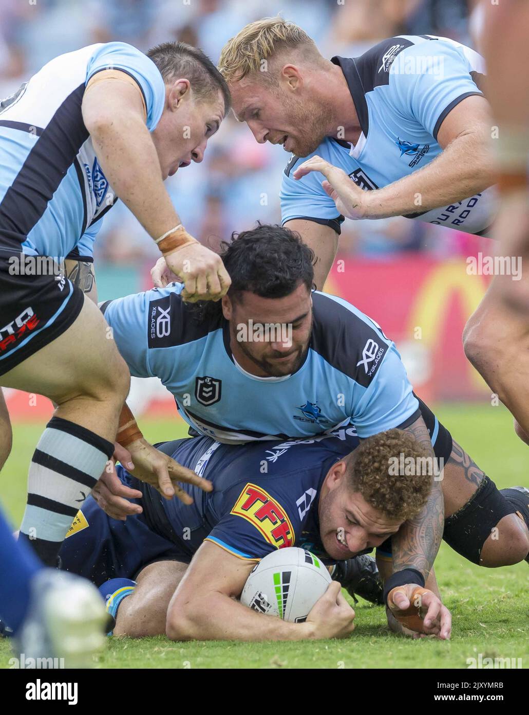 Brenko Lee of the Titans is tackled during the Round 2 NRL match ...